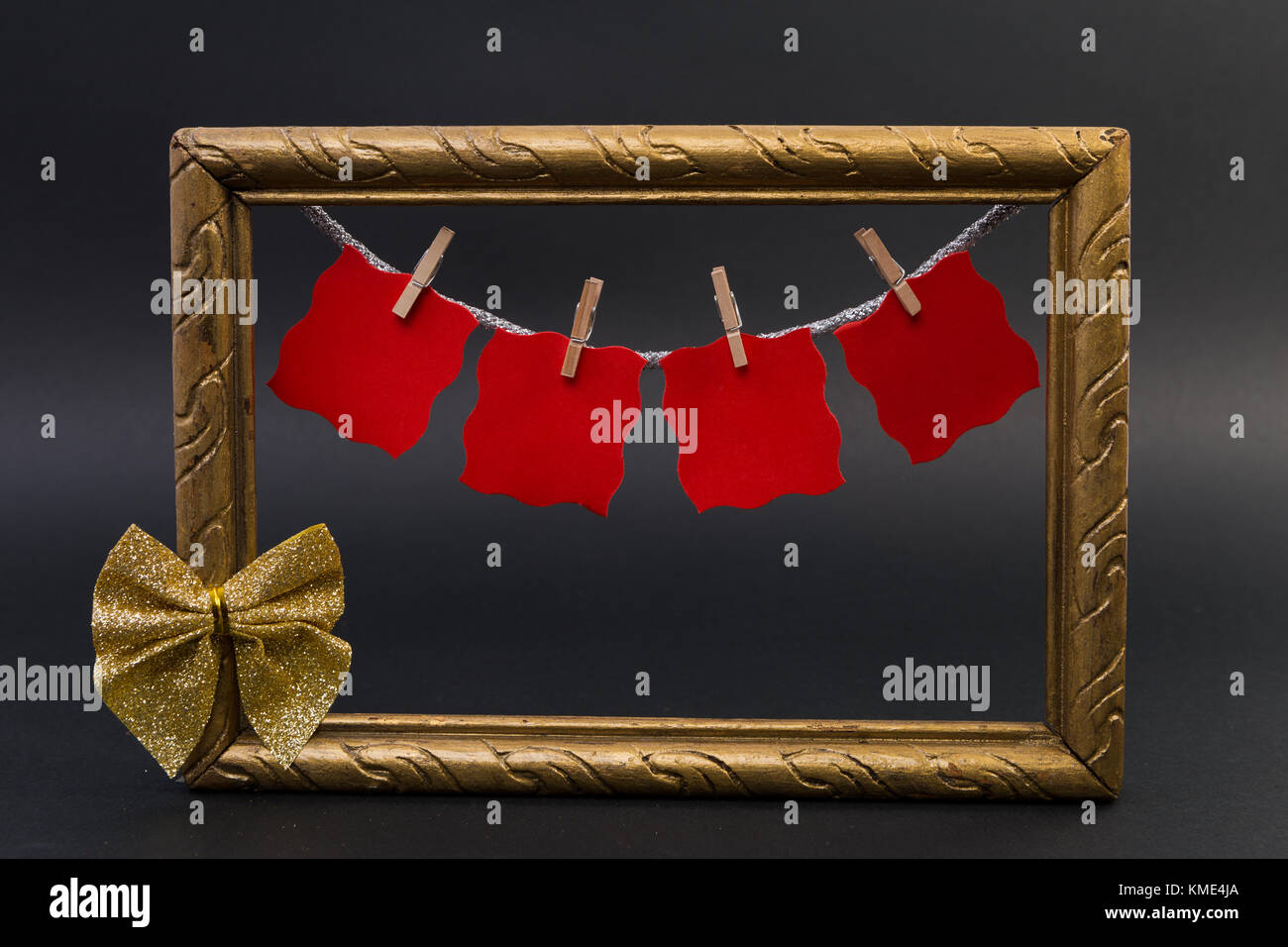 Happy celebration photo frame with four hanging papers having empty ...