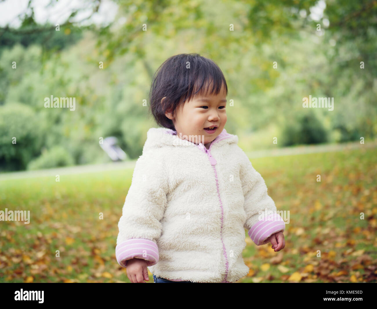 Baby girl playing at Autumn outdoor park Stock Photo - Alamy