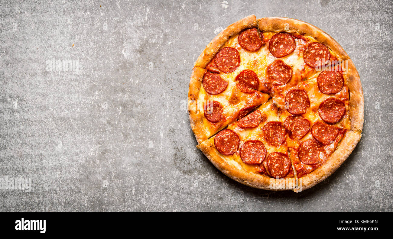 Pepperoni pizza top view. On the stone table. Free space for text . Top ...