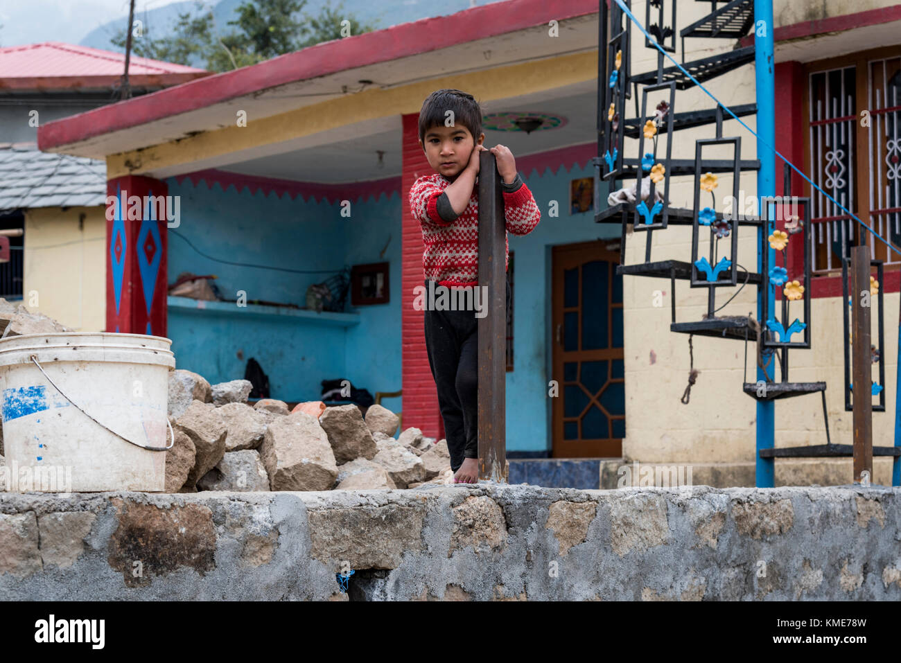 A young boy stading in front of his house Stock Photo - Alamy
