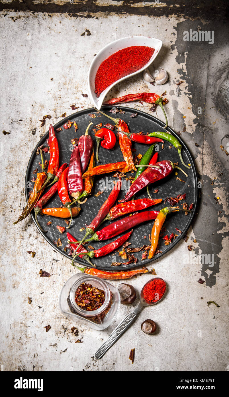 Dried chili peppers on a tray with crushed red pepper in the cups, with ...