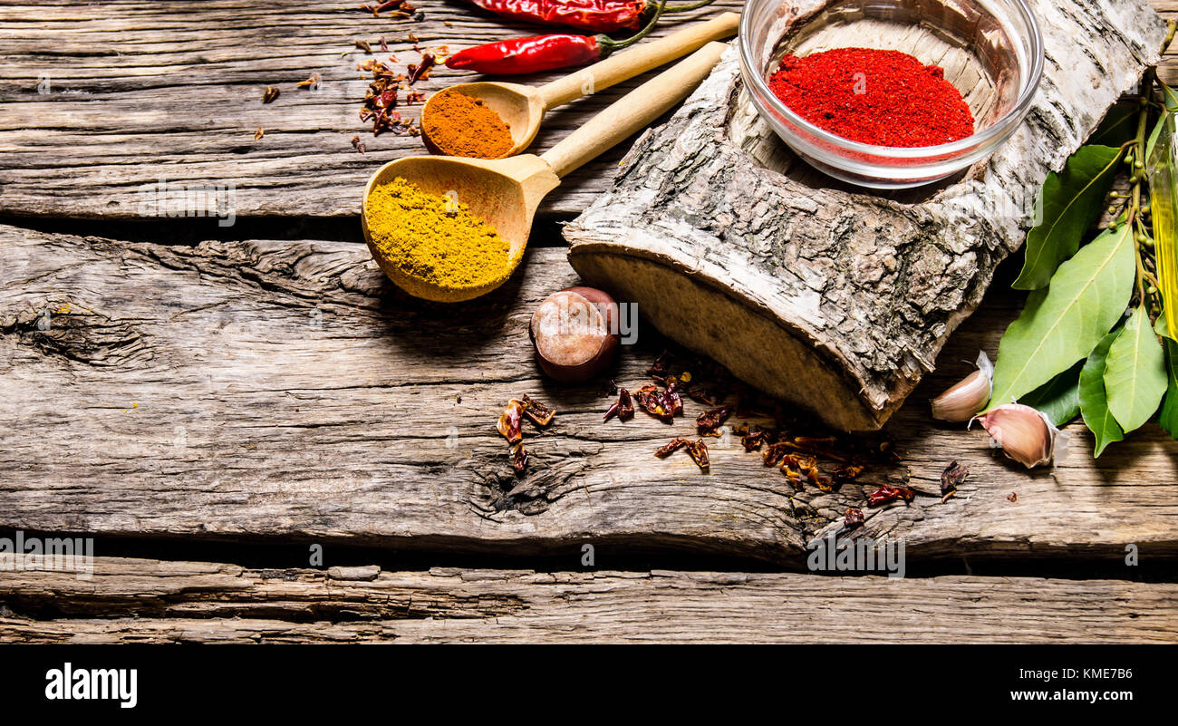 Pepper, on birch stand with aromatic spices and herbs. On wooden ...