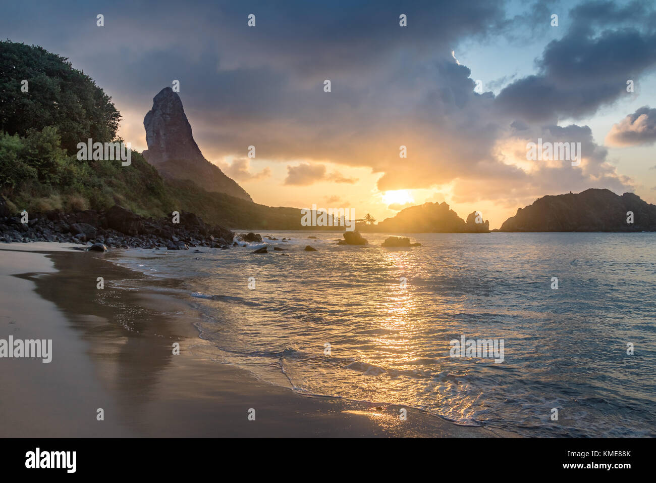 Sunset at Praia do Cachorro Beach with Morro do Pico on background ...