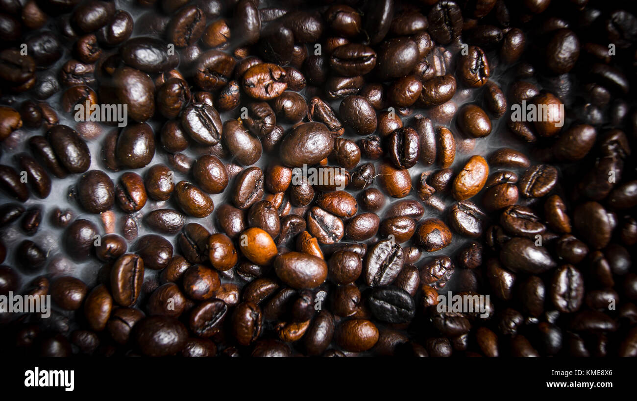 Fragrant fried coffee beans. With smoke roasting Stock Photo - Alamy