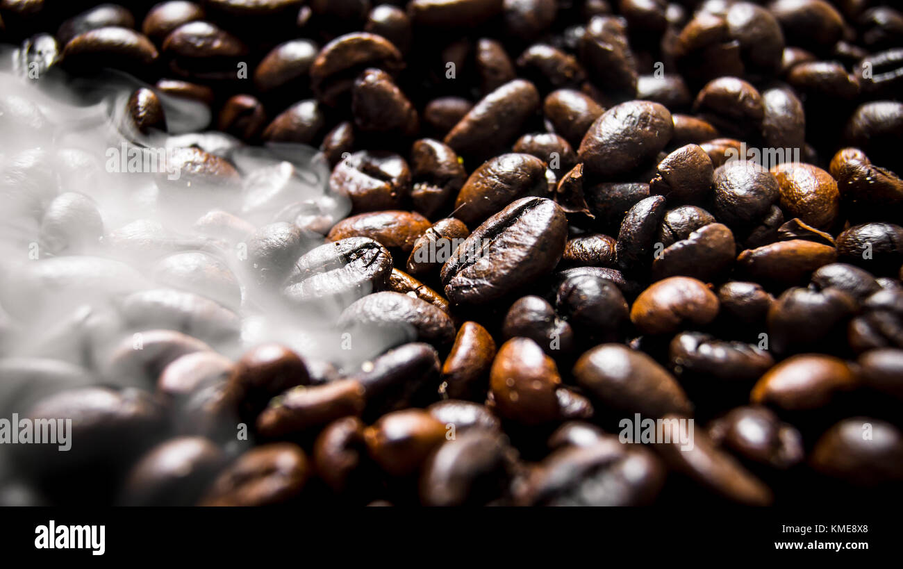 Fragrant fried coffee beans. With smoke roasting Stock Photo - Alamy