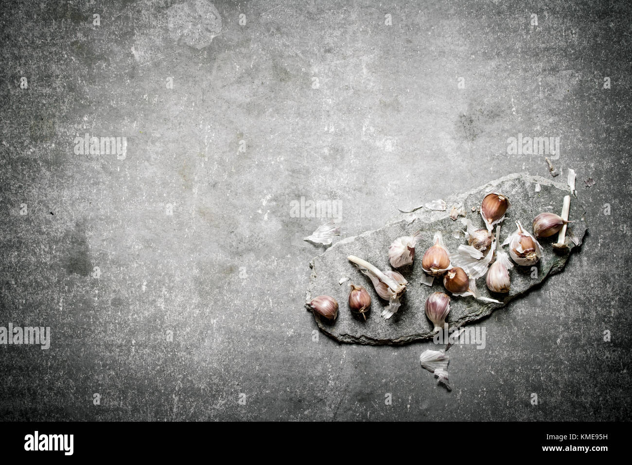 Fresh garlic on a stone stand. On a stone background Stock Photo - Alamy