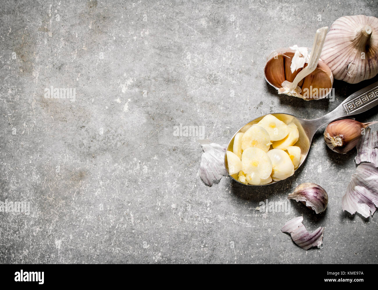 Garlic background. Chopped garlic in a spoon and the whole garlic . On ...
