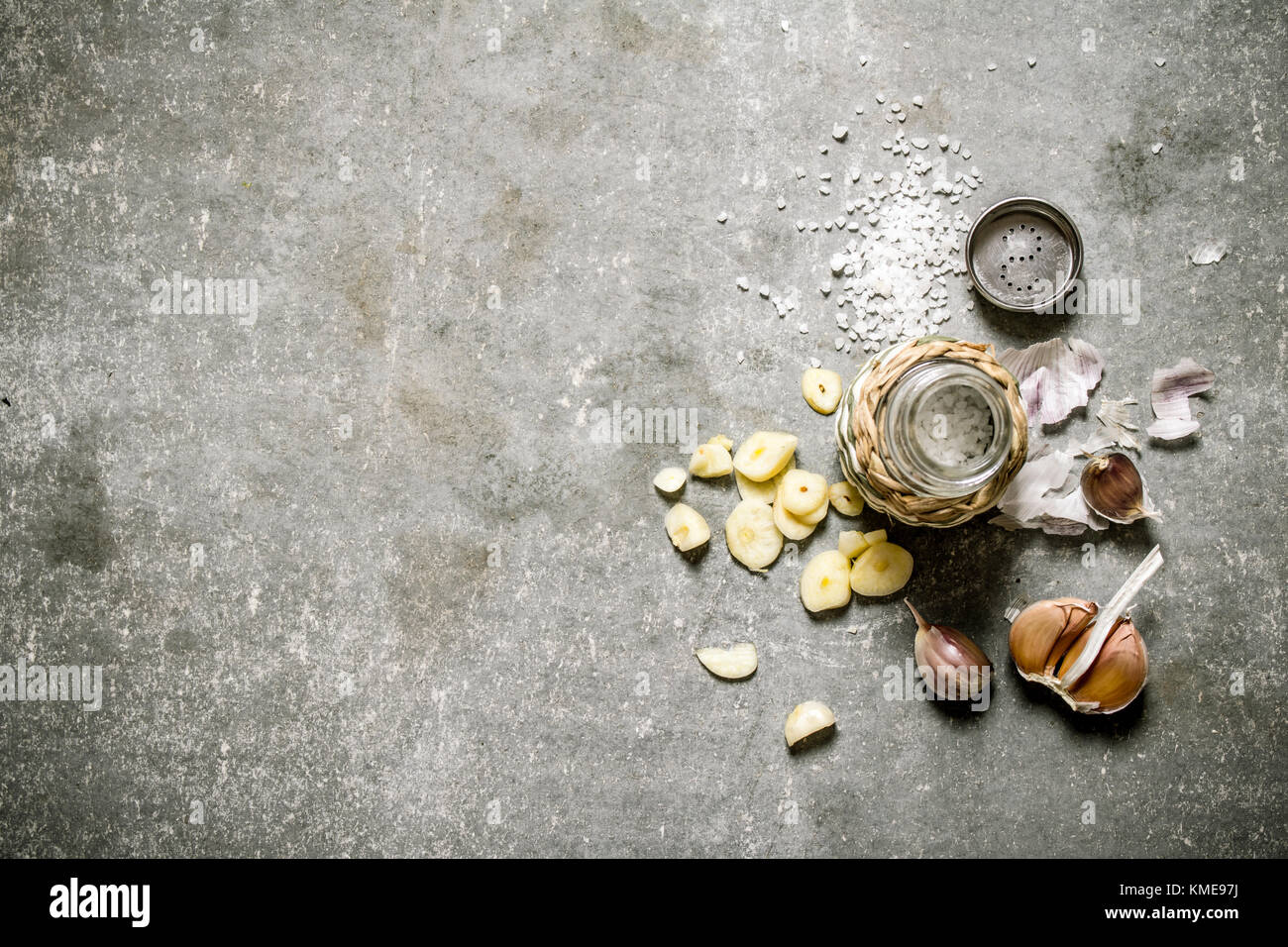 Spicy background. Fragrant garlic salt. On a stone background Stock ...