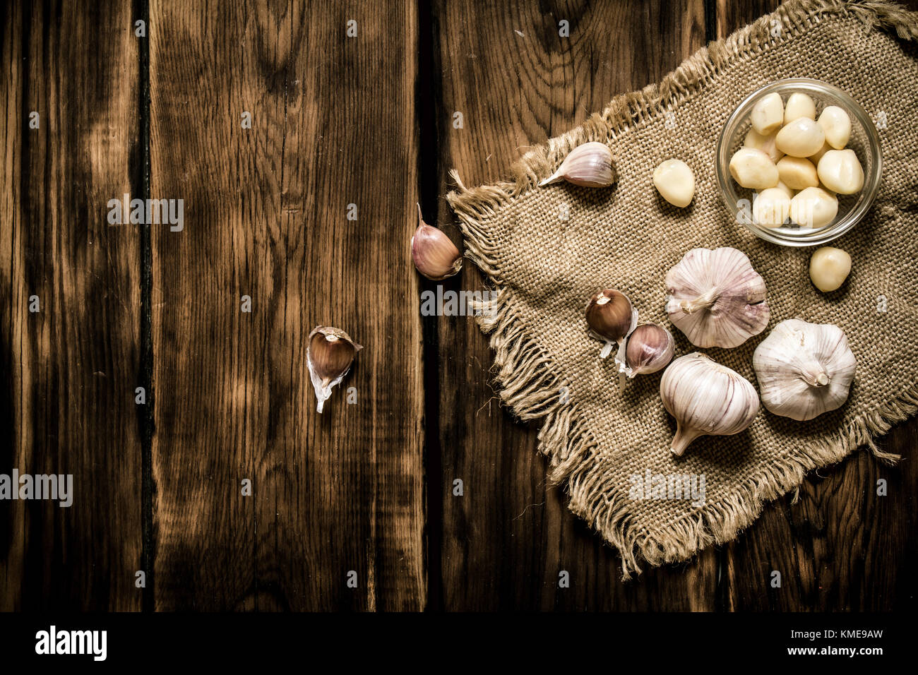 Peeled garlic on an old fabric. On wooden background Stock Photo - Alamy