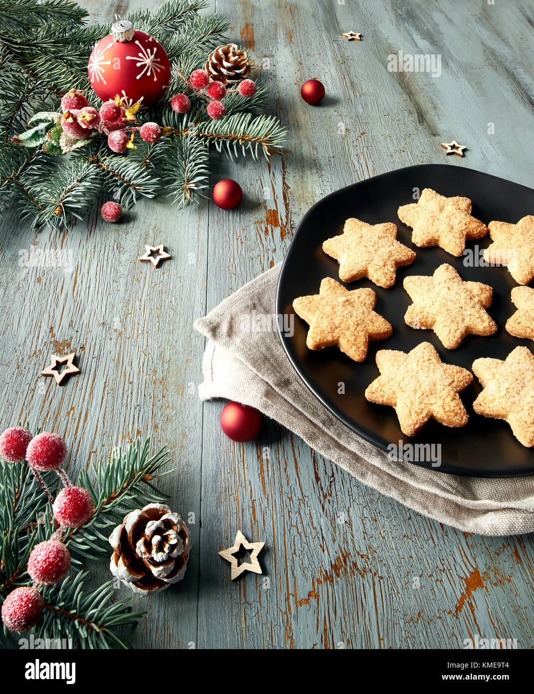 Rustic Christmas background in green and red. Star-shaped cookies on ...