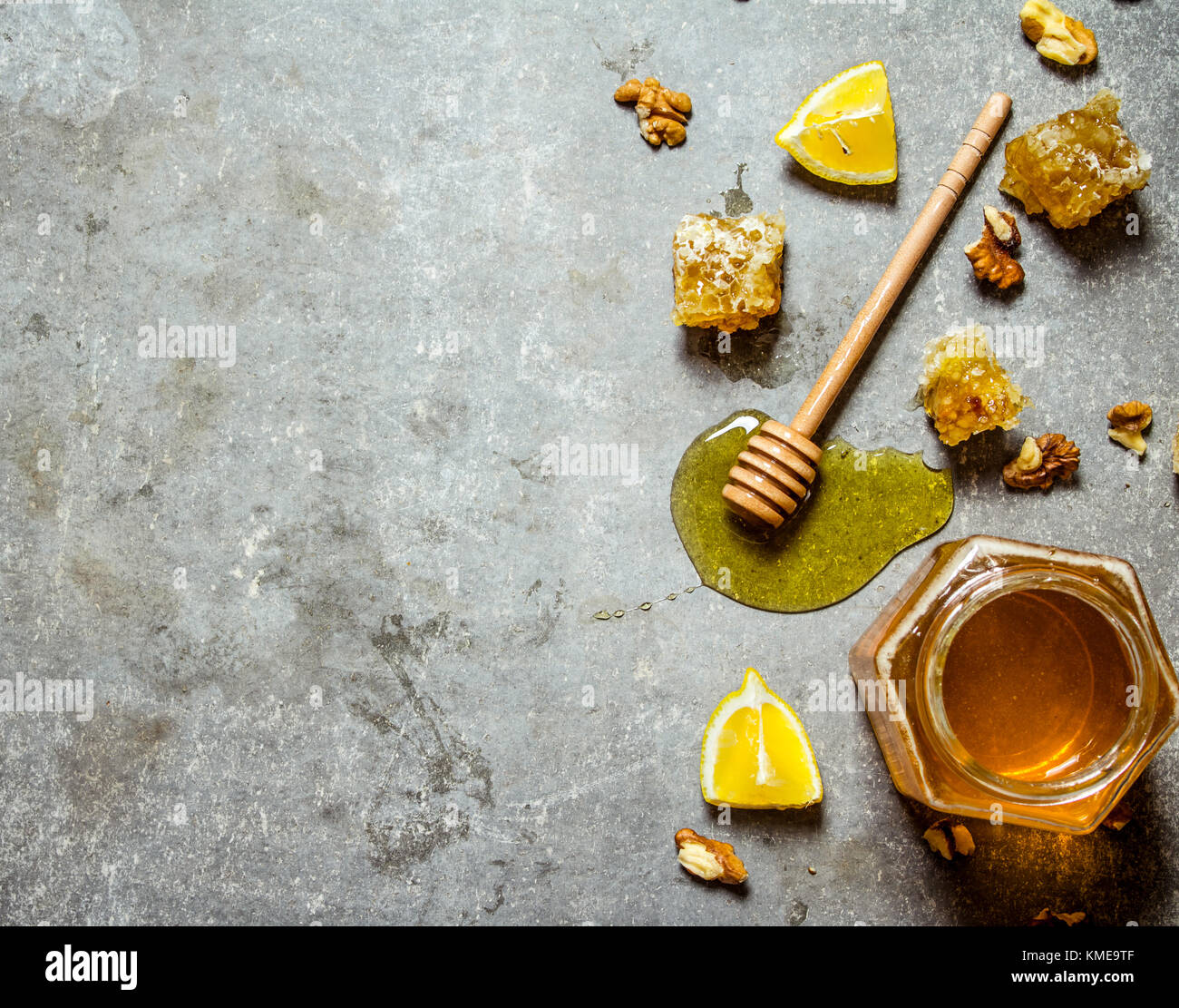 Honey background. Natural honey with slices of lemon and walnuts. On ...