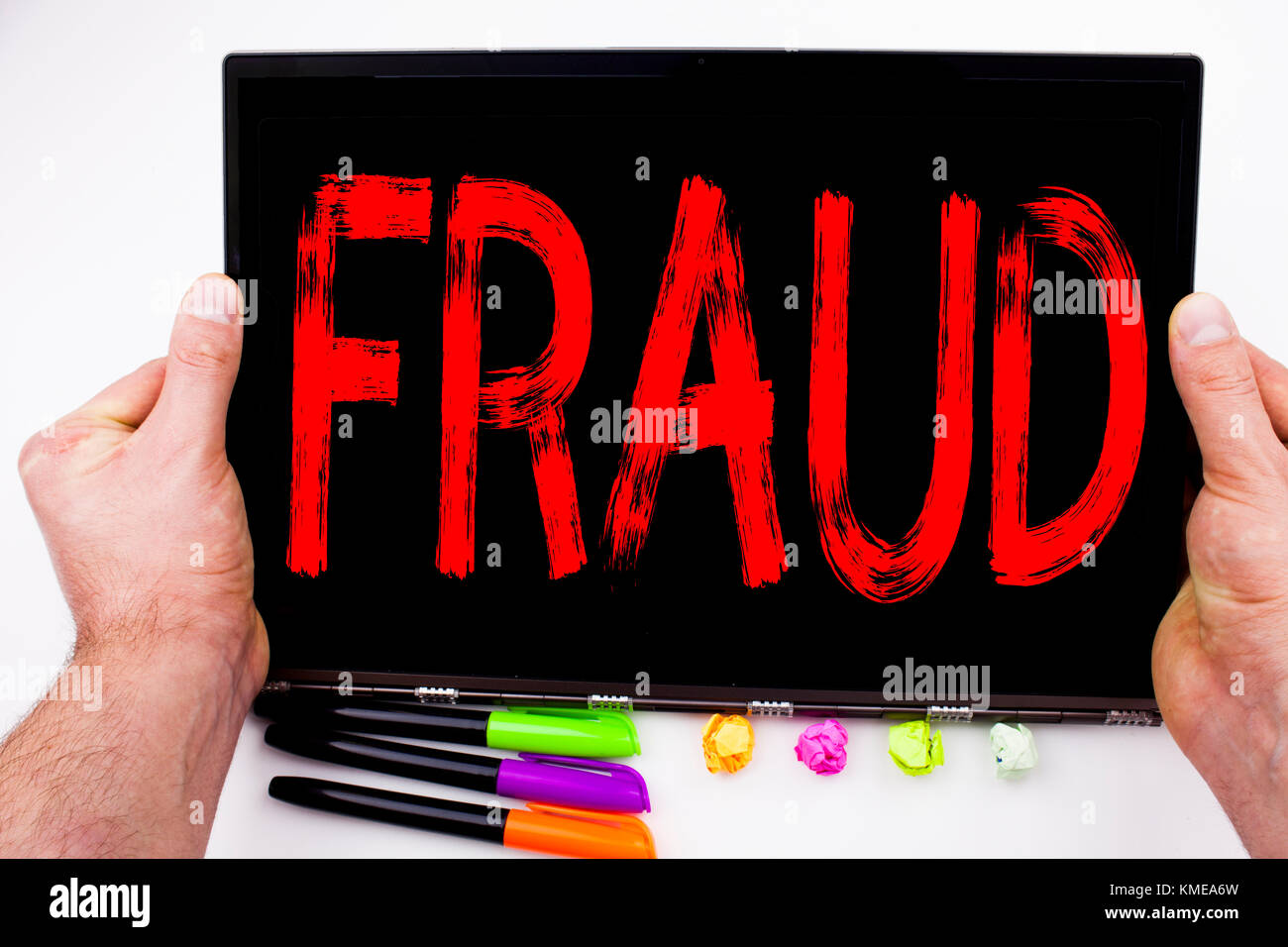 Fraud text written on tablet, computer in the office with marker, pen ...