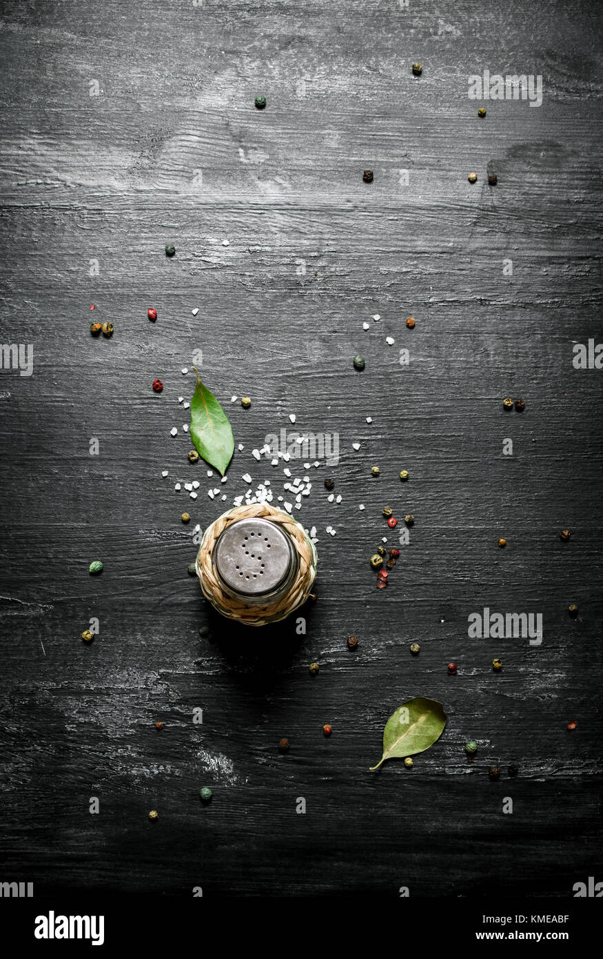The salt and spices. On a black rustic background Stock Photo - Alamy