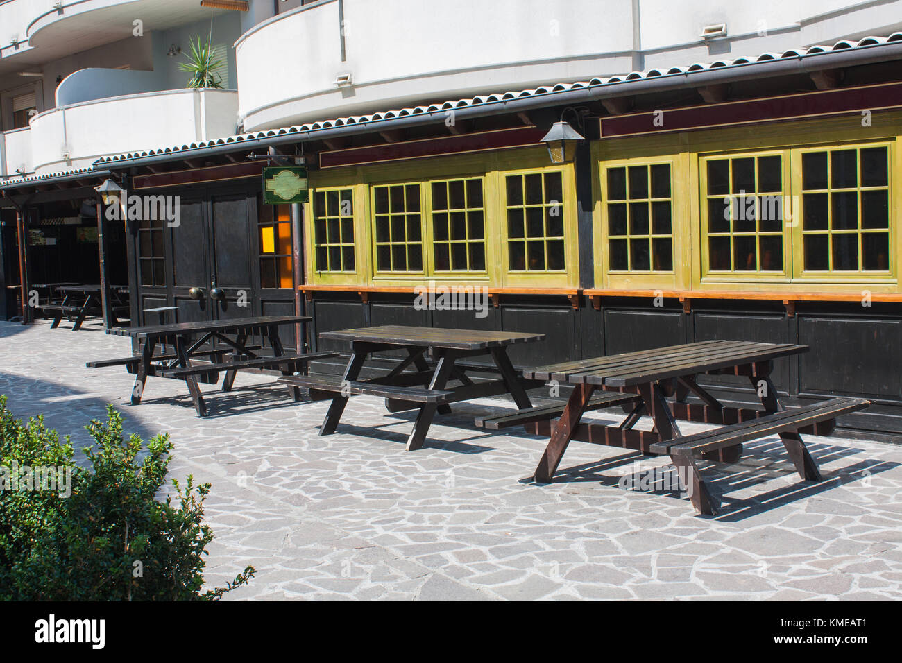 Pub or Bar Exterior with Wooden Tables in Open Air Stock Photo - Alamy