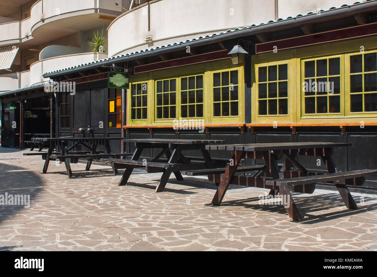 Pub or Bar Exterior with Wooden Tables in Open Air Stock Photo - Alamy
