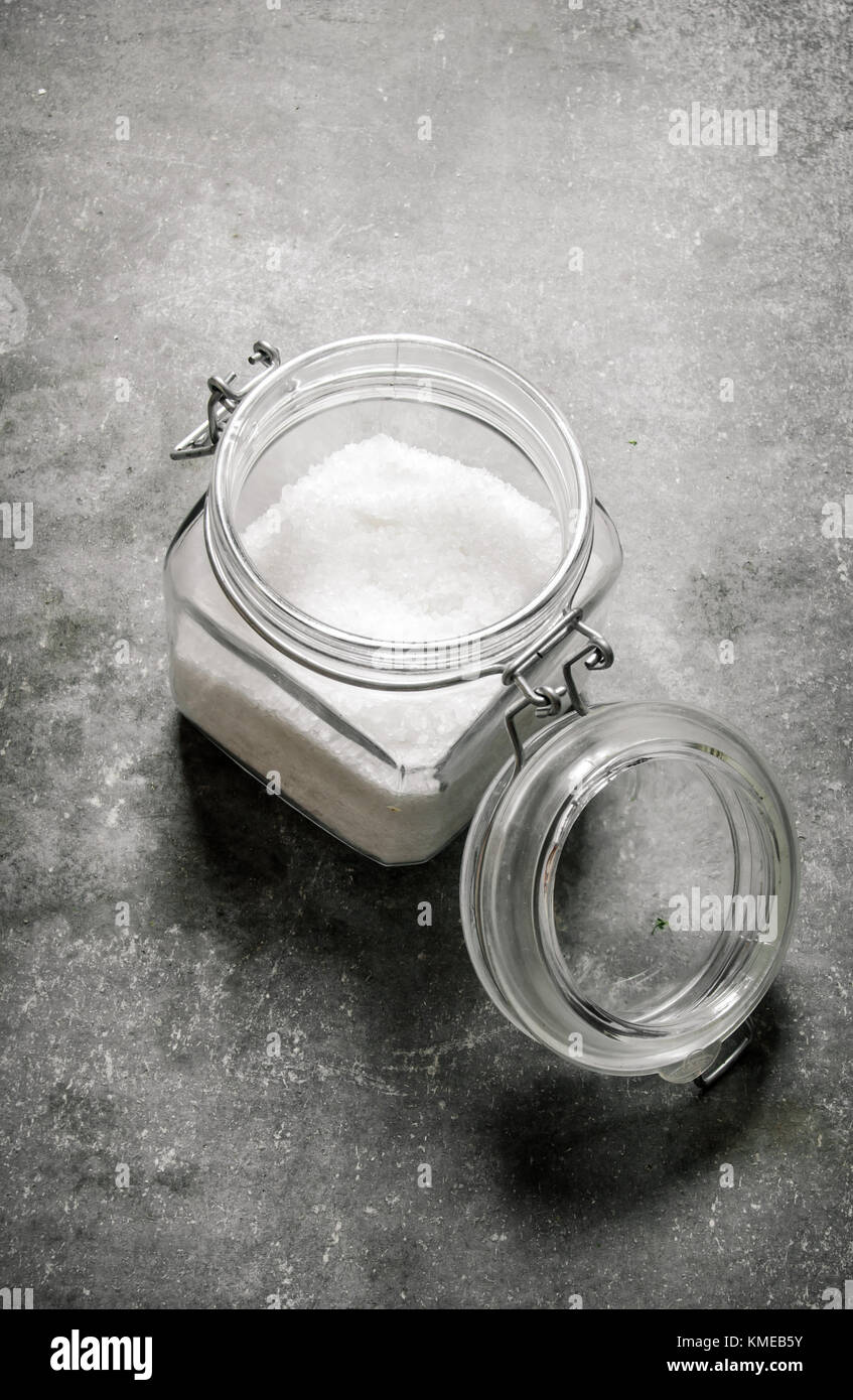 Glass jar of salt . On a stone background Stock Photo - Alamy