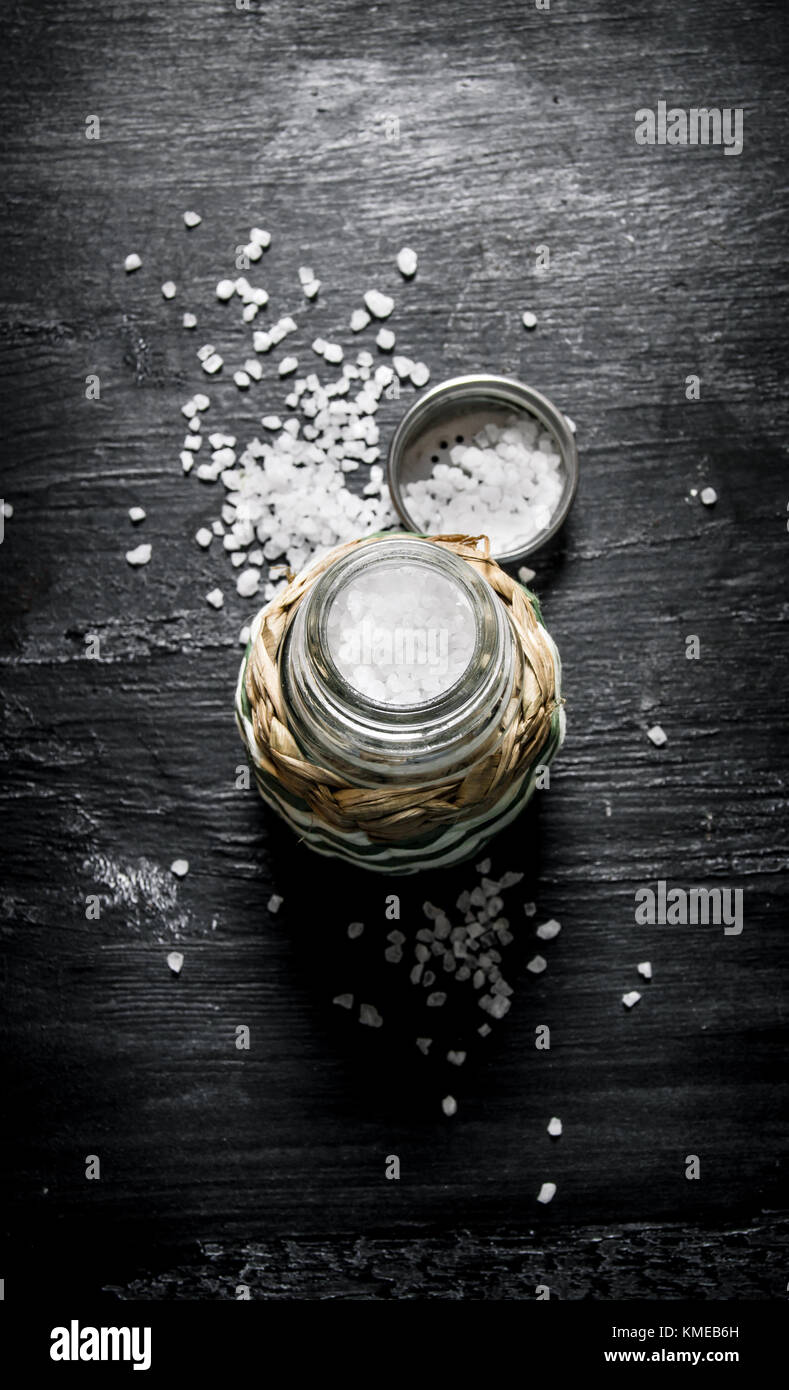 Coarse salt in saltcellar. On a black rustic background Stock Photo - Alamy