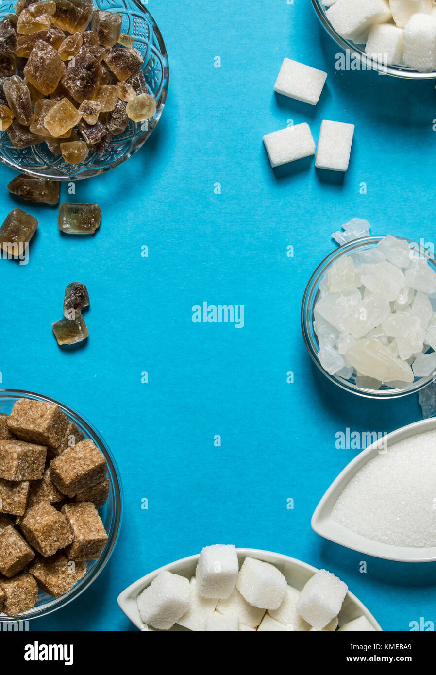 Different types of brown and white sugar. On a blue table Stock Photo ...