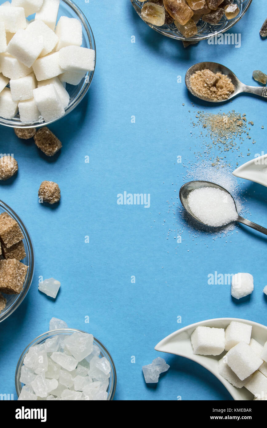 Different types of brown and white sugar. On a blue table Stock Photo ...