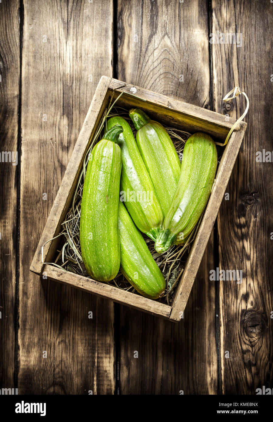 Fresh zucchini in an old box. On wooden background Stock Photo - Alamy