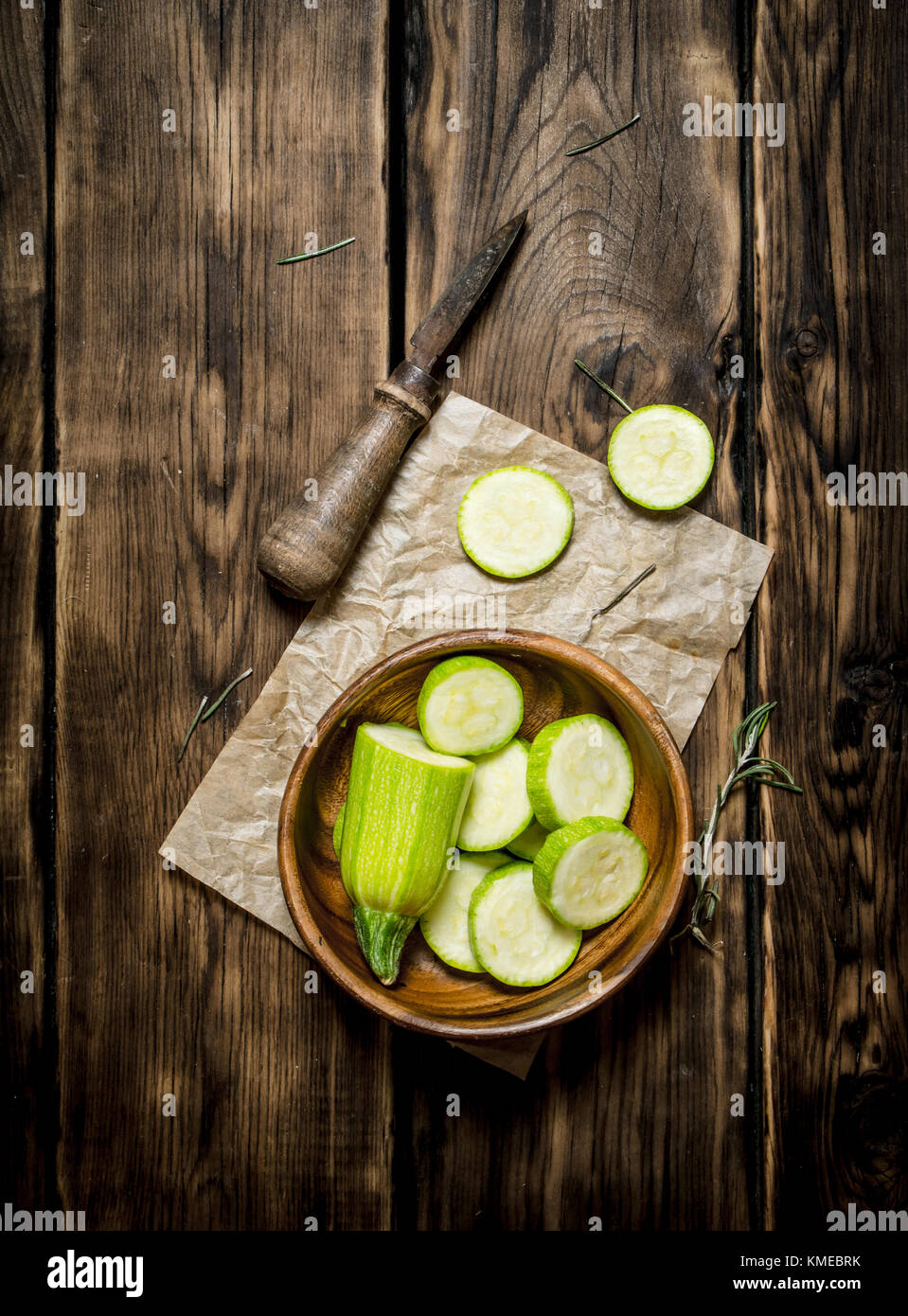 Sliced zucchini and an old knife . On wooden background Stock Photo - Alamy
