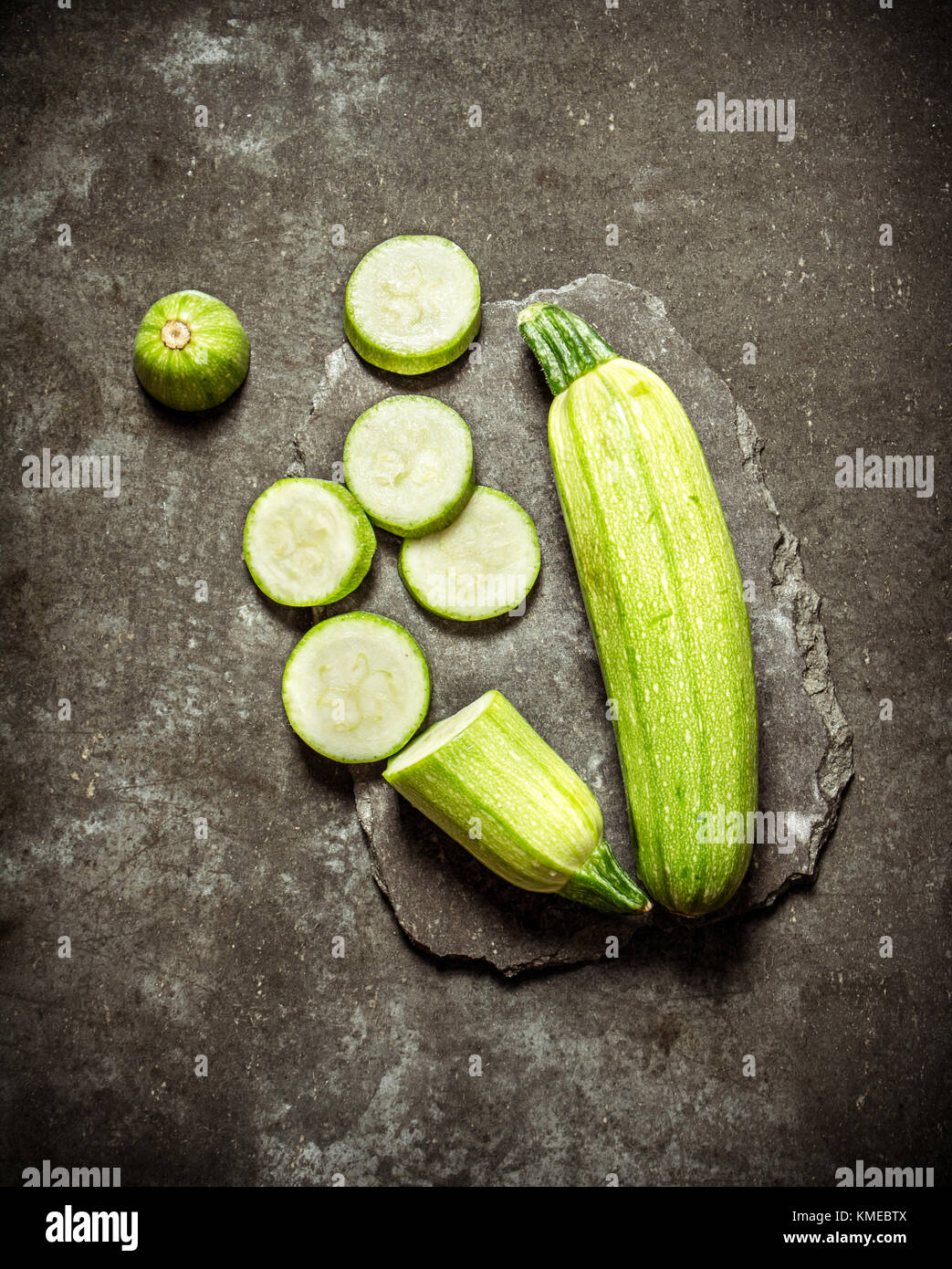 Sliced zucchini on a stone stand. On a stone background Stock Photo - Alamy