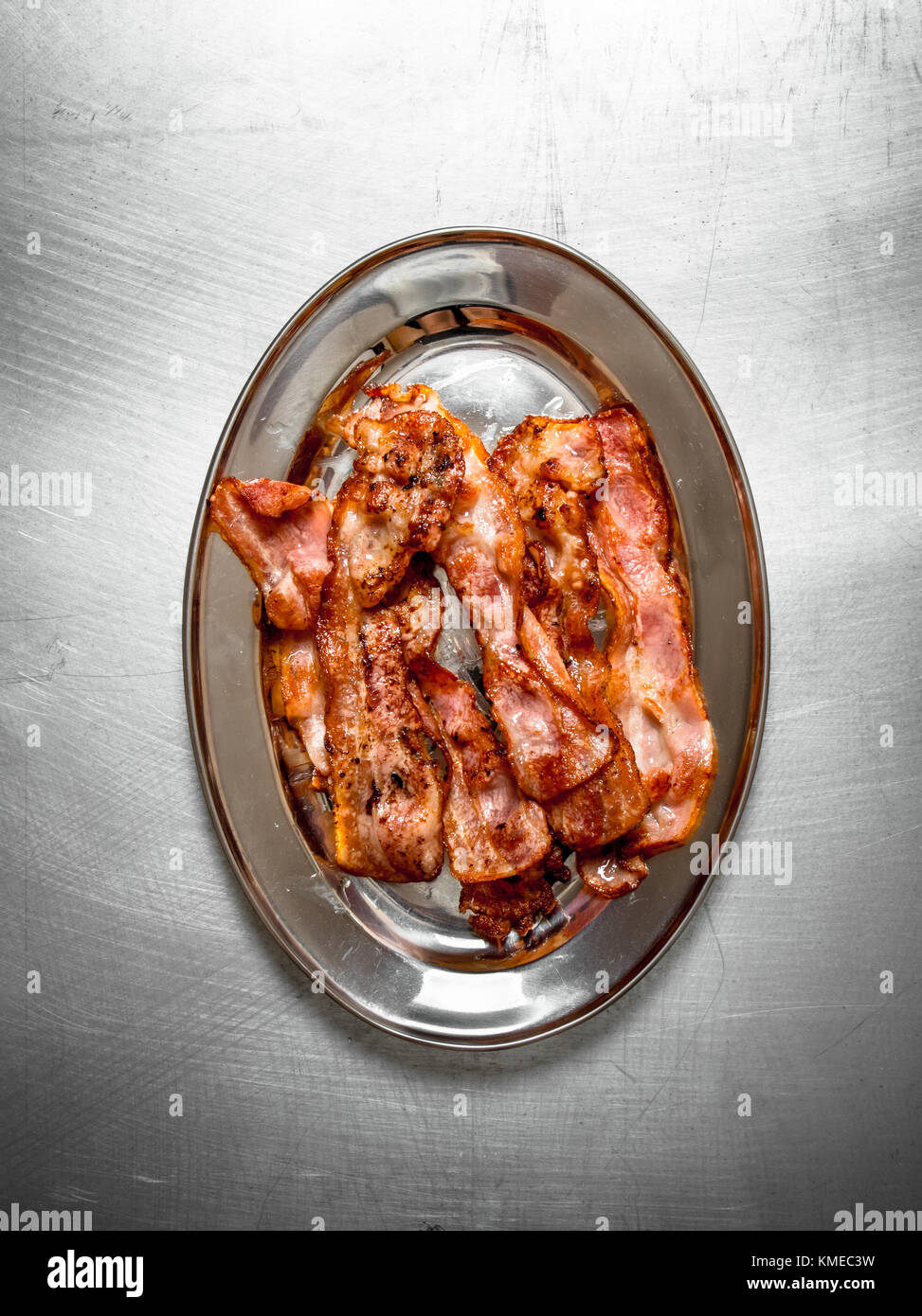 Fried bacon on a plate. On the Metal table Stock Photo - Alamy