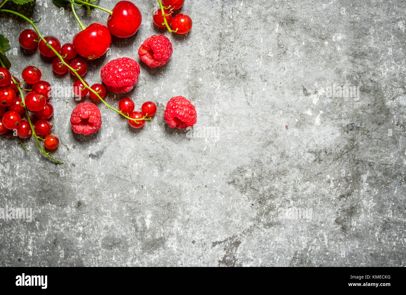 Red forest berries . On a stone background Stock Photo - Alamy