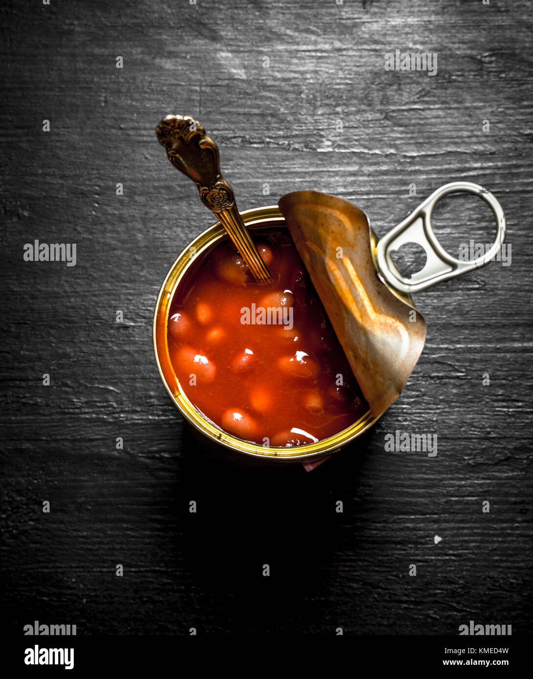 Red tinned beans. On a black wooden background Stock Photo - Alamy