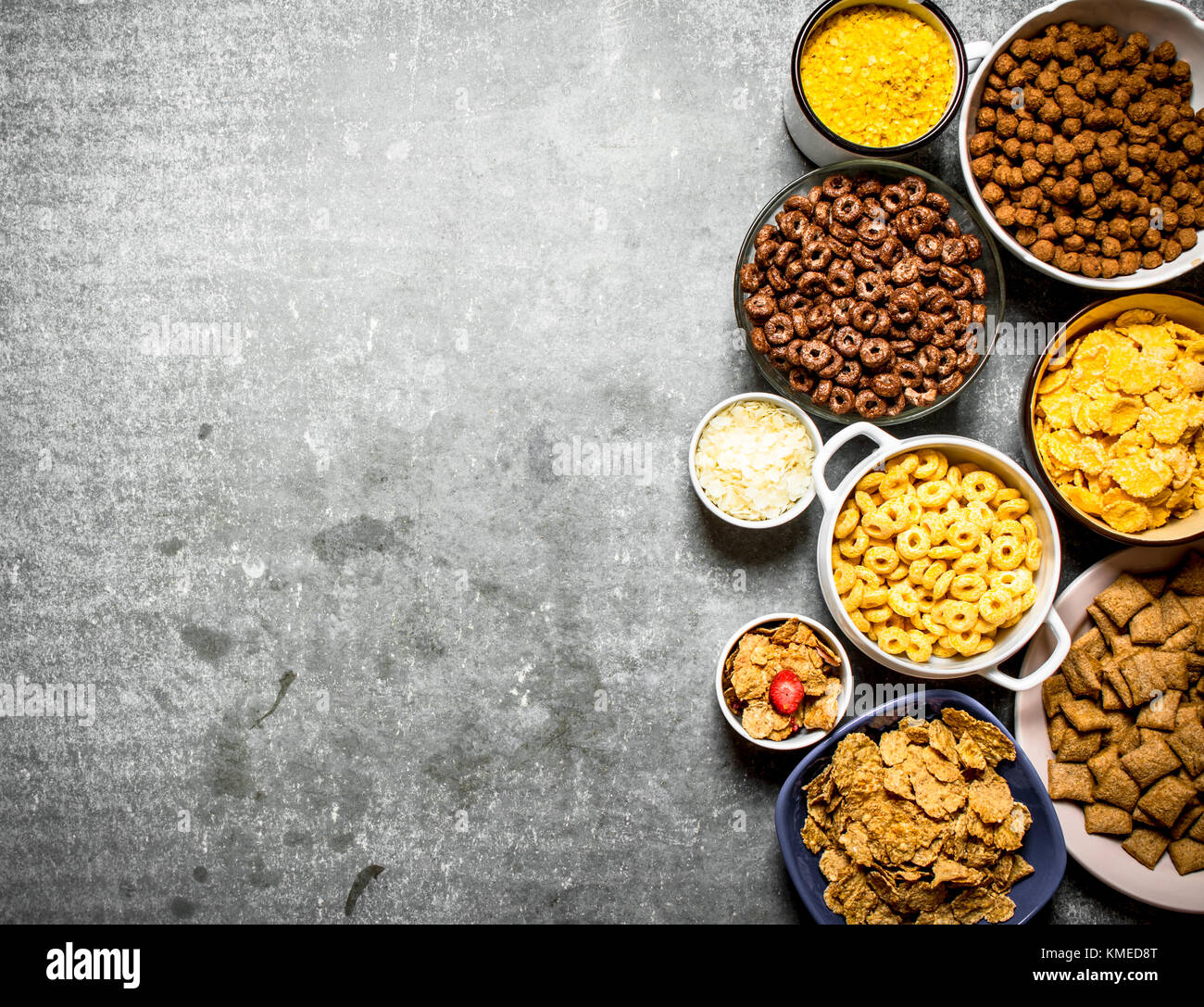 Various cereals in bowls. On the stone table Stock Photo - Alamy