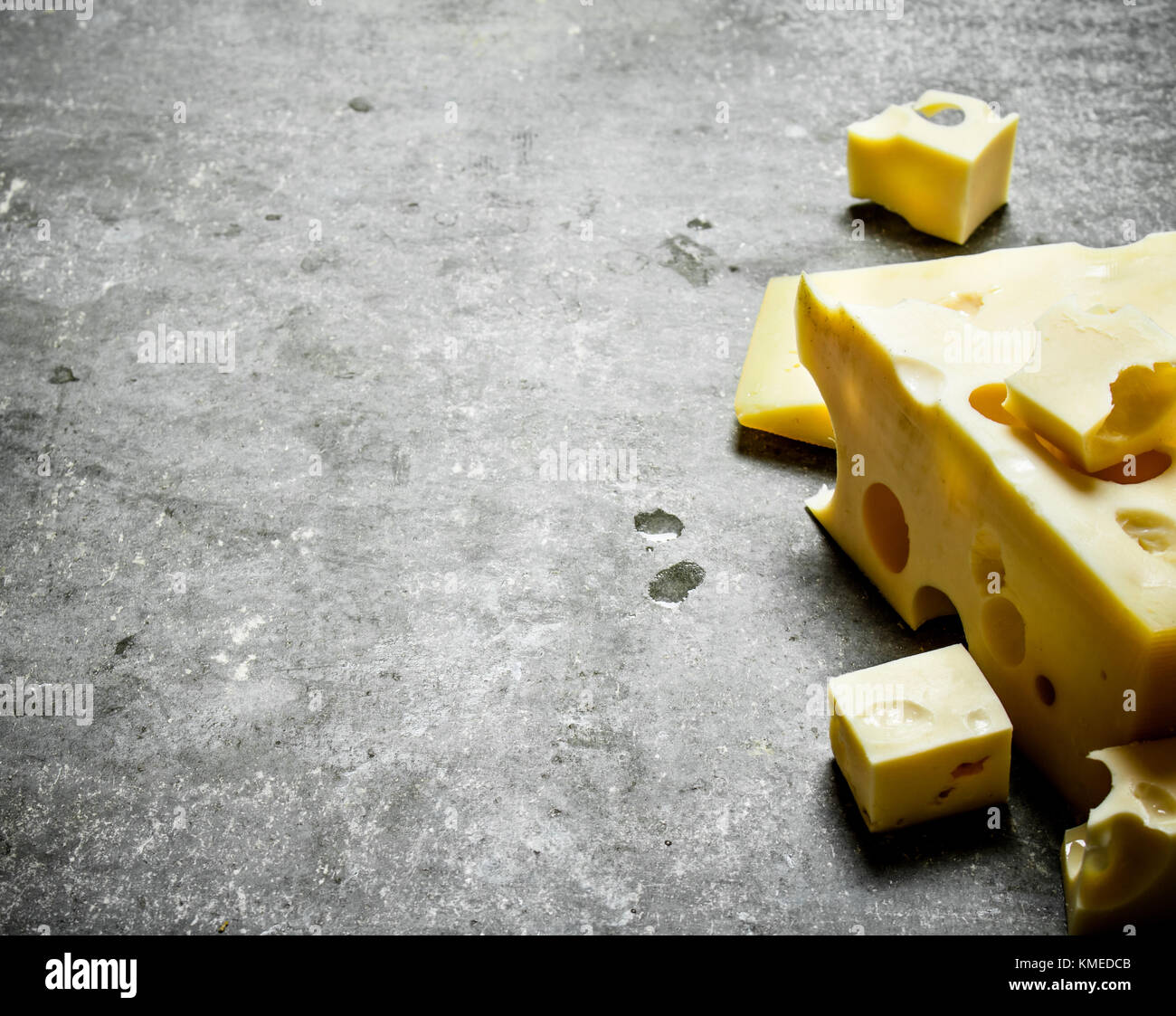 Fresh cheddar cheese. On the stone table Stock Photo - Alamy