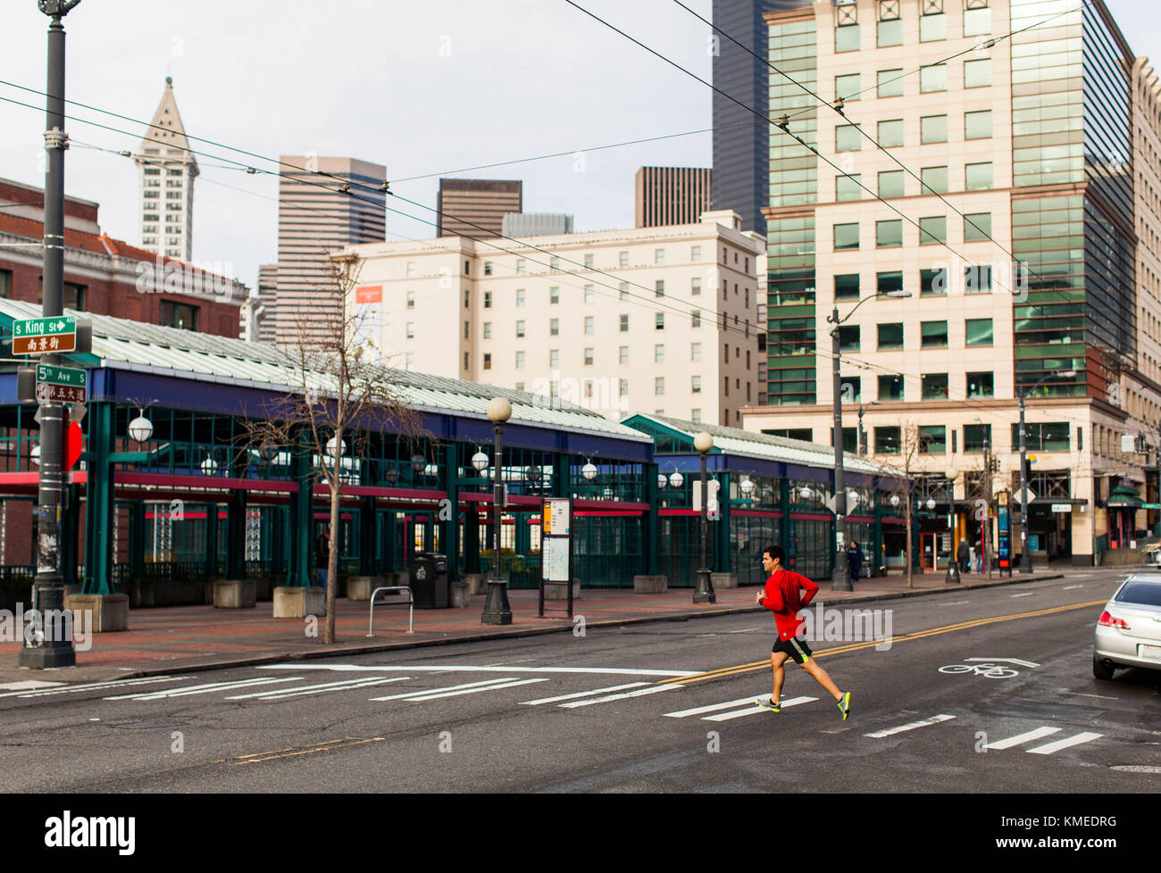 A male runner crosses a street in downtown Seattle yesterday during a ...