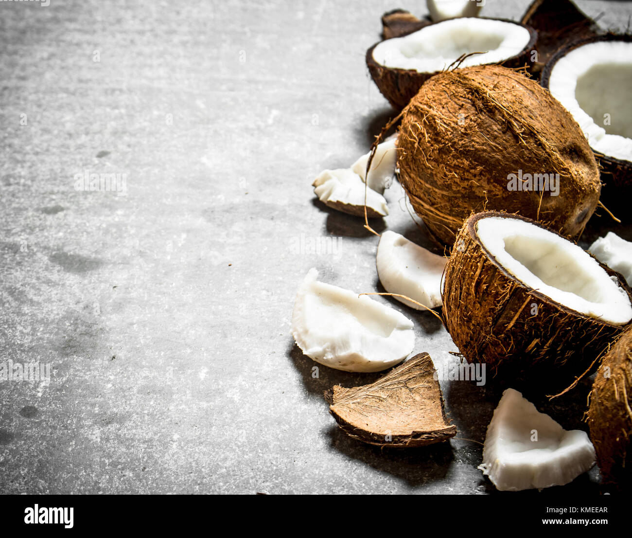Fresh hard coconuts. On a stone background Stock Photo - Alamy