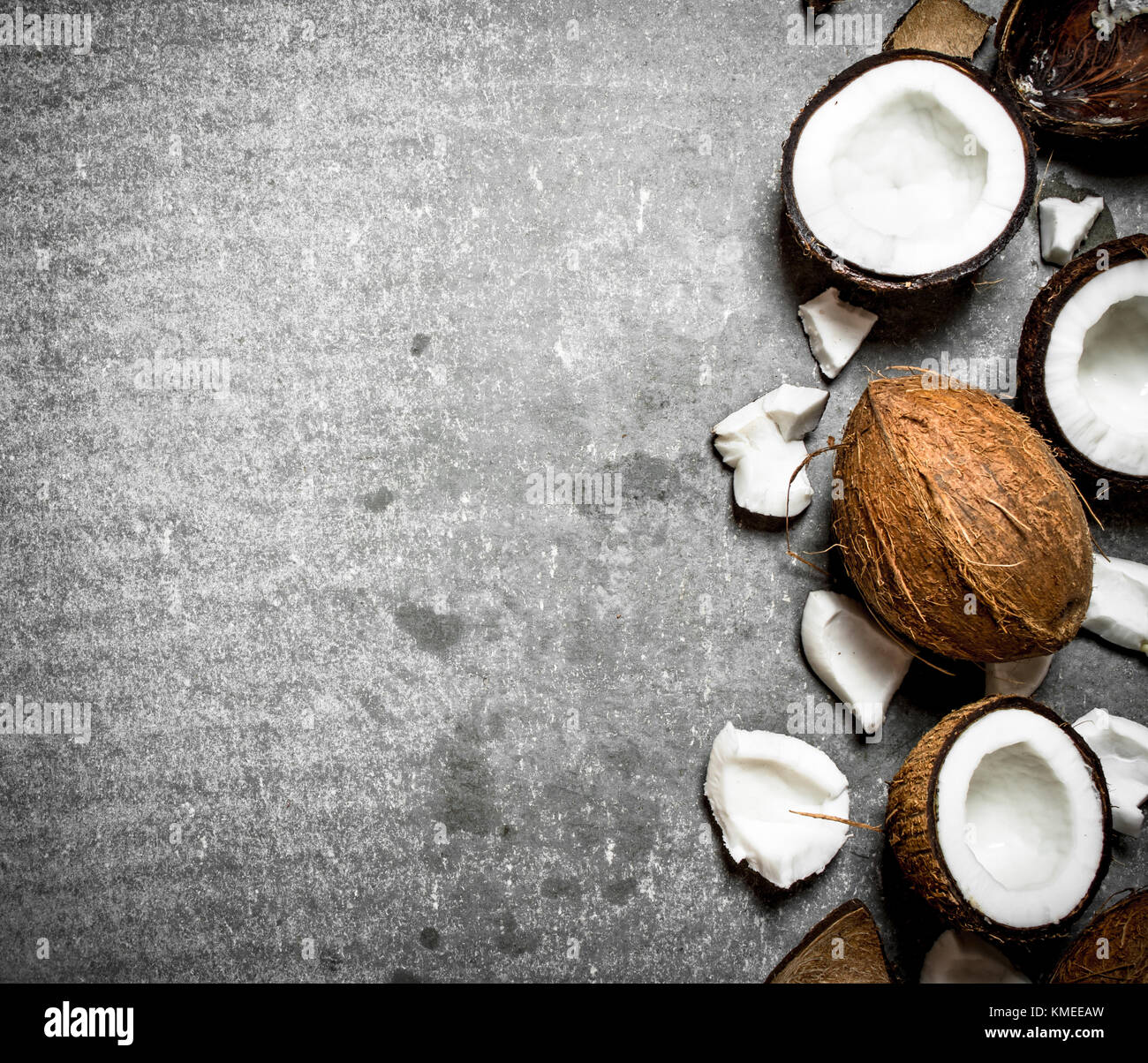 Fresh hard coconuts. On a stone background Stock Photo - Alamy