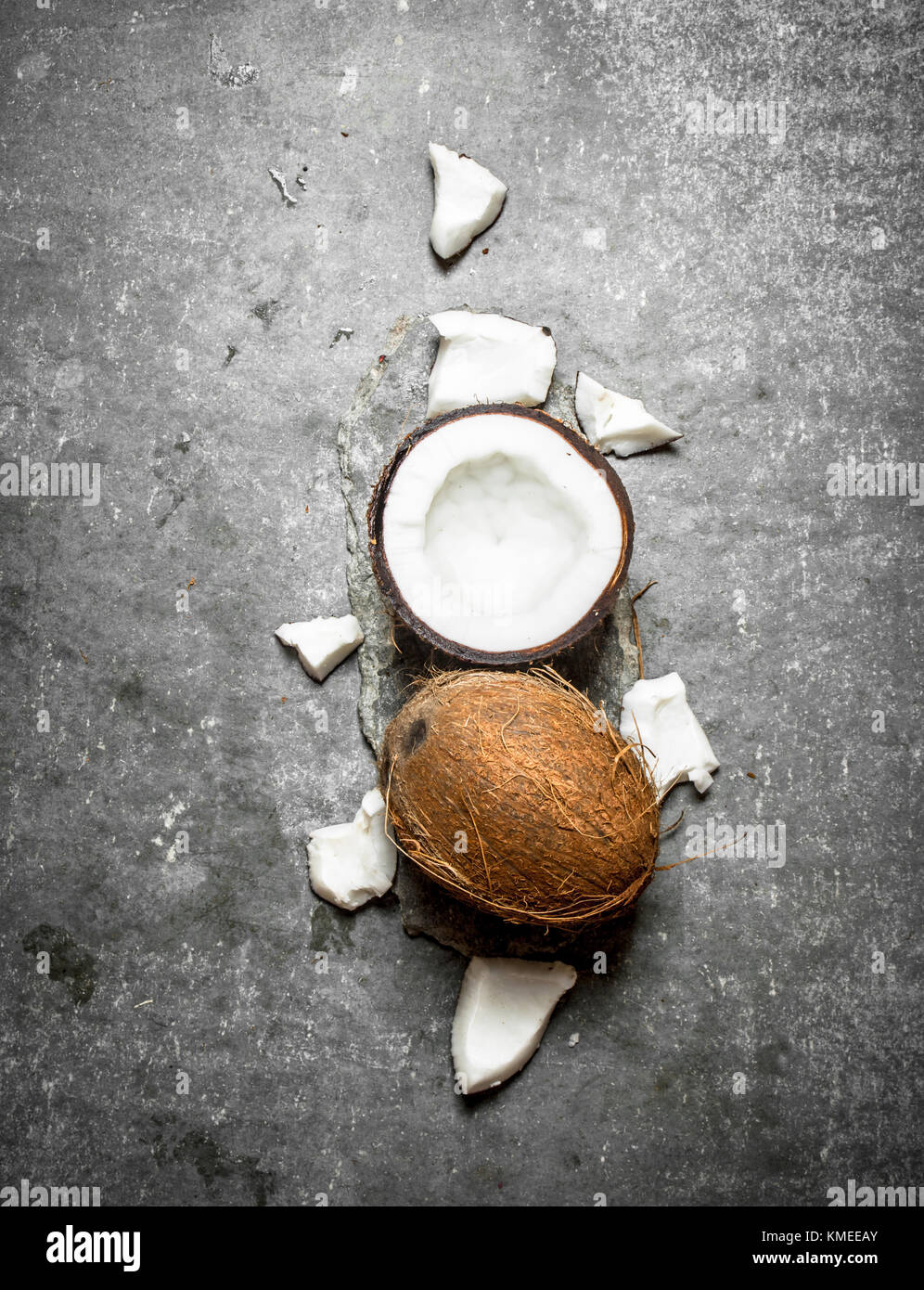 Fresh hard coconuts. On a stone background Stock Photo - Alamy