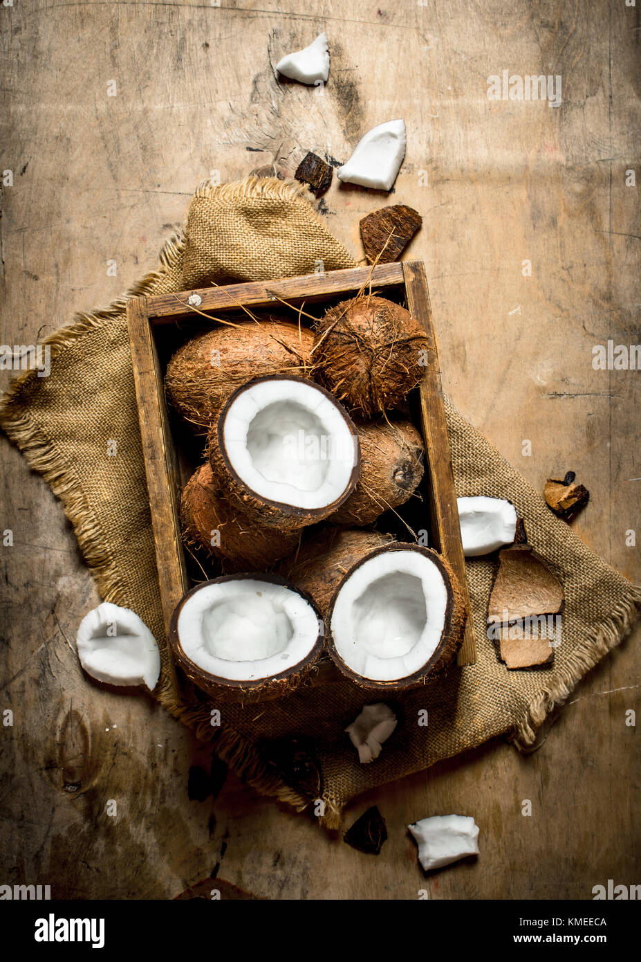 Fresh coconuts in an old box. On wooden background Stock Photo - Alamy