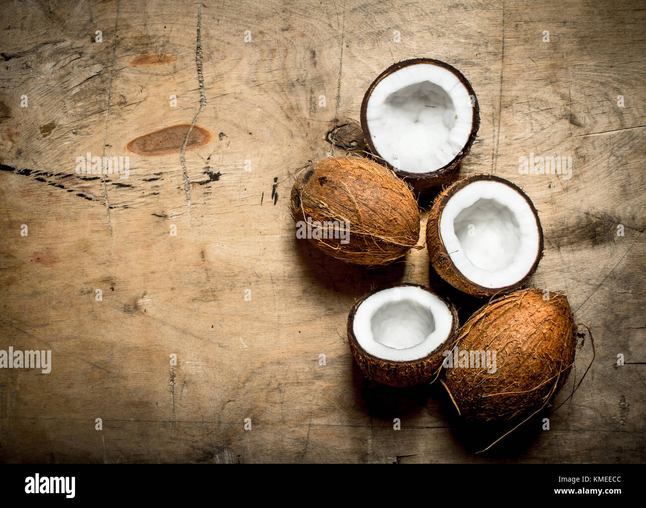 Fresh hard coconuts. On a wooden background Stock Photo - Alamy