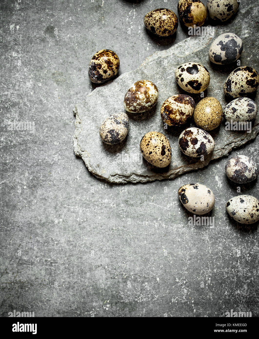The quail eggs. On the stone table Stock Photo - Alamy