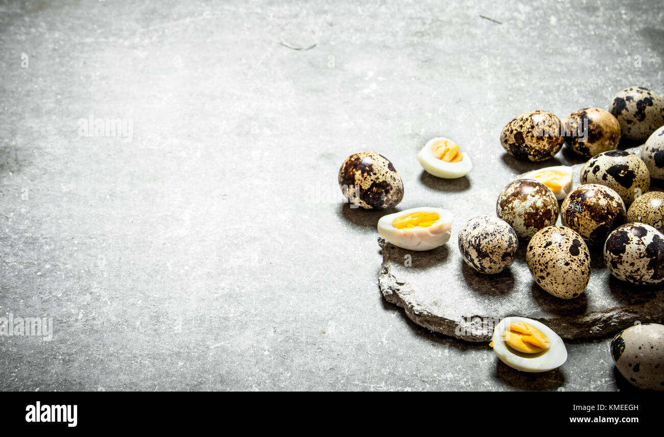 The quail eggs. On the stone table Stock Photo - Alamy