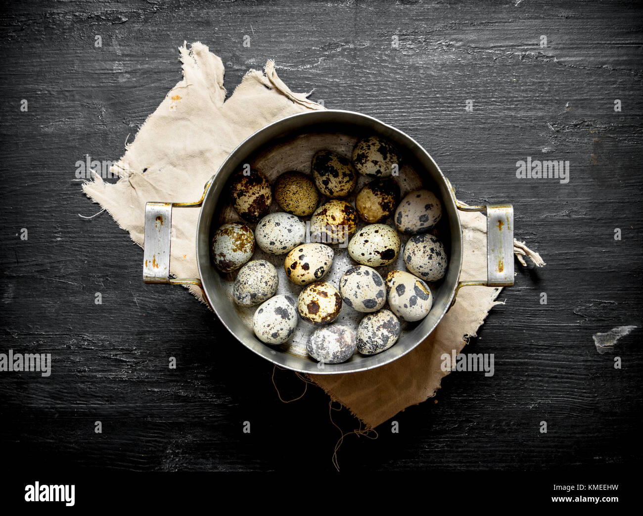 Quail eggs in an old pot. On a black wooden background Stock Photo - Alamy