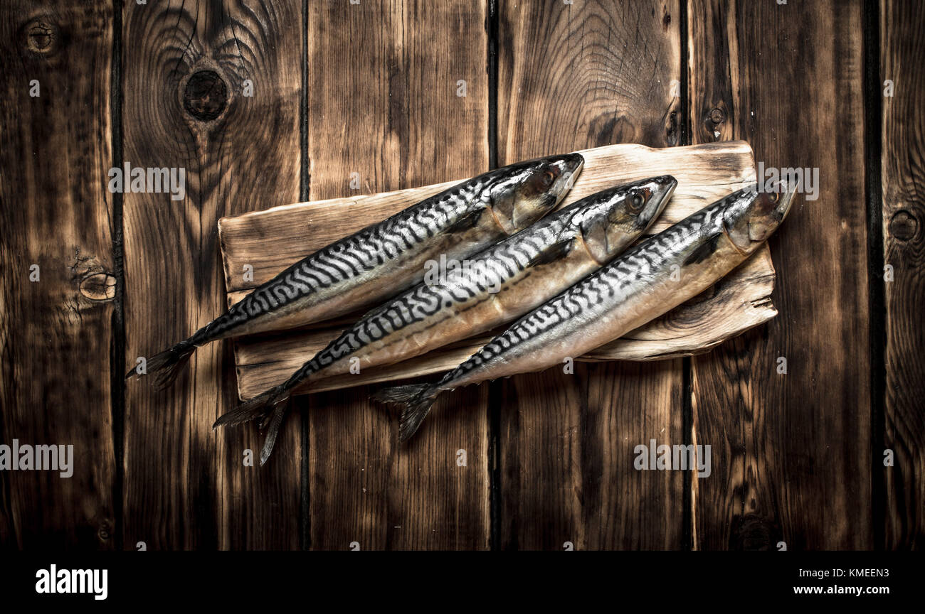 Raw fish on the Board. On wooden background Stock Photo - Alamy