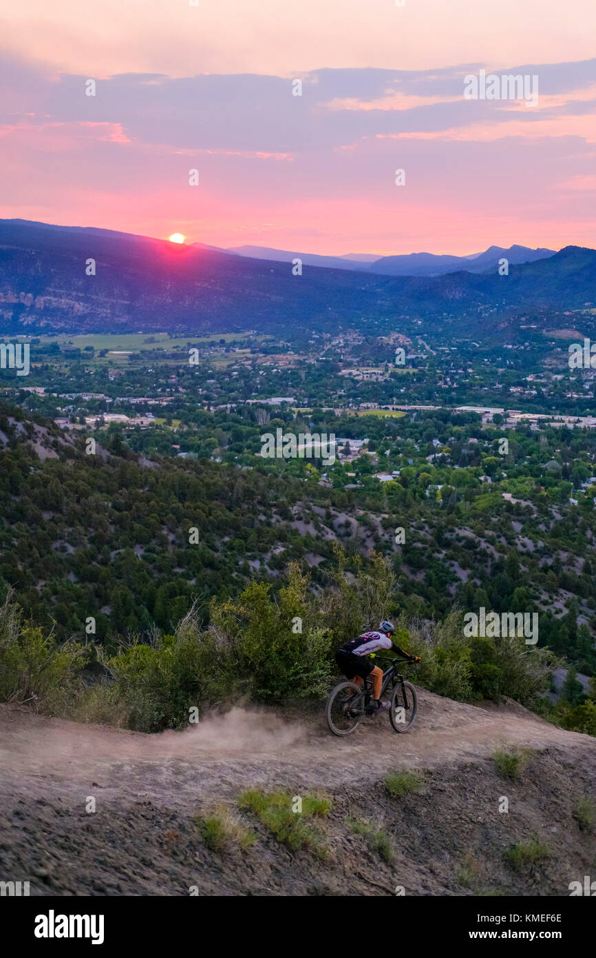Male Mountain Biker rides down Hogs back near Durango at sunset ...