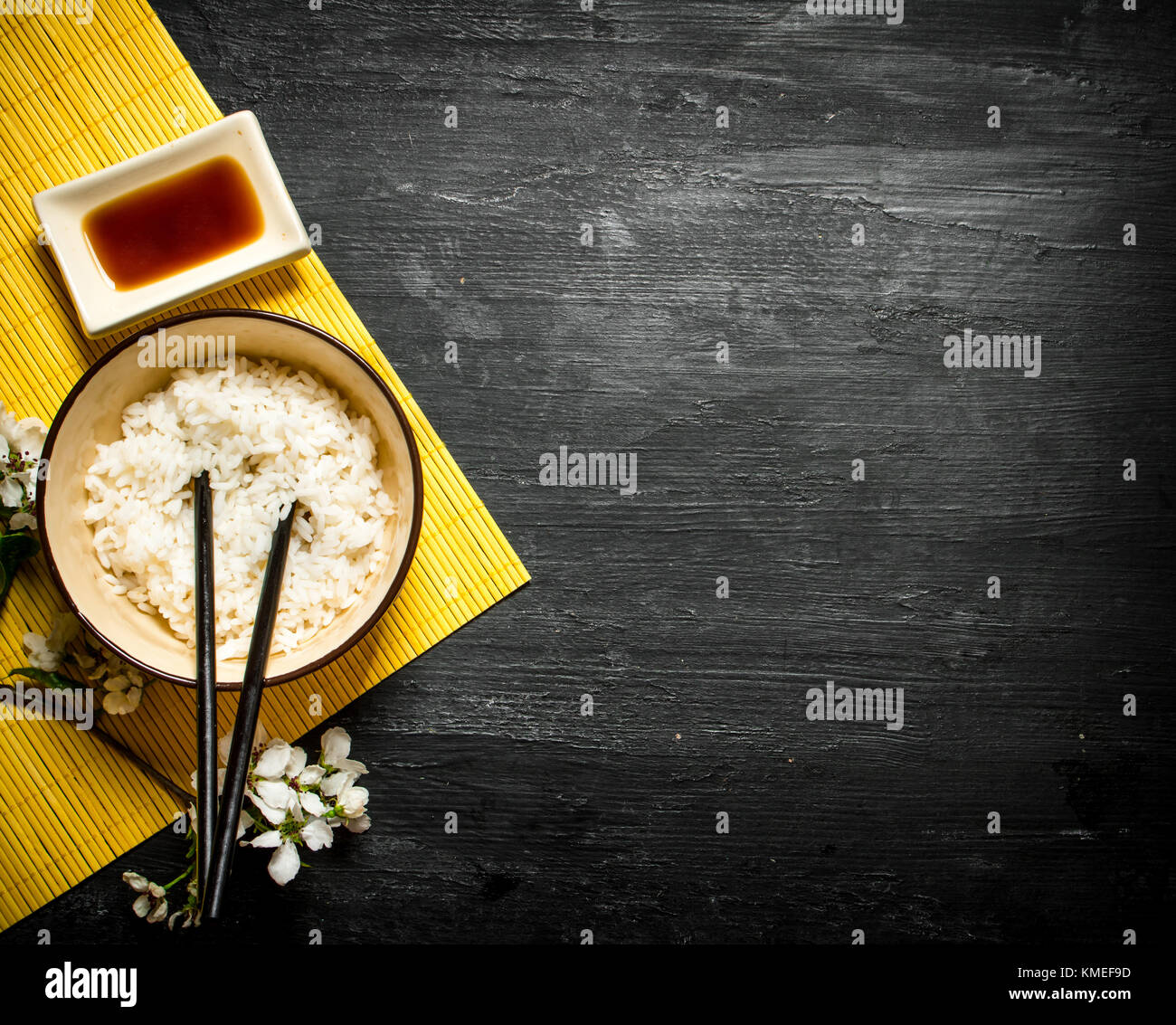 Japanese food. Boiled rice with soy sauce and the cherry branches Stock ...