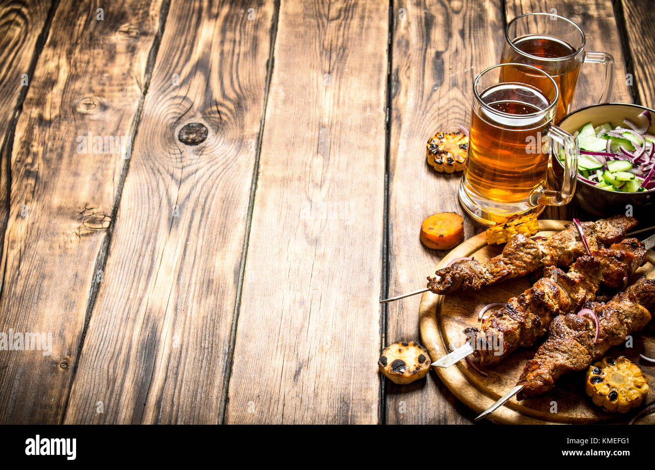 Pork kebab with beer and vegetables. On wooden background Stock Photo ...