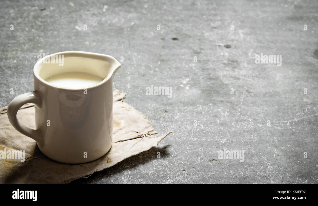 Fresh milk in a mug. On the stone table Stock Photo - Alamy