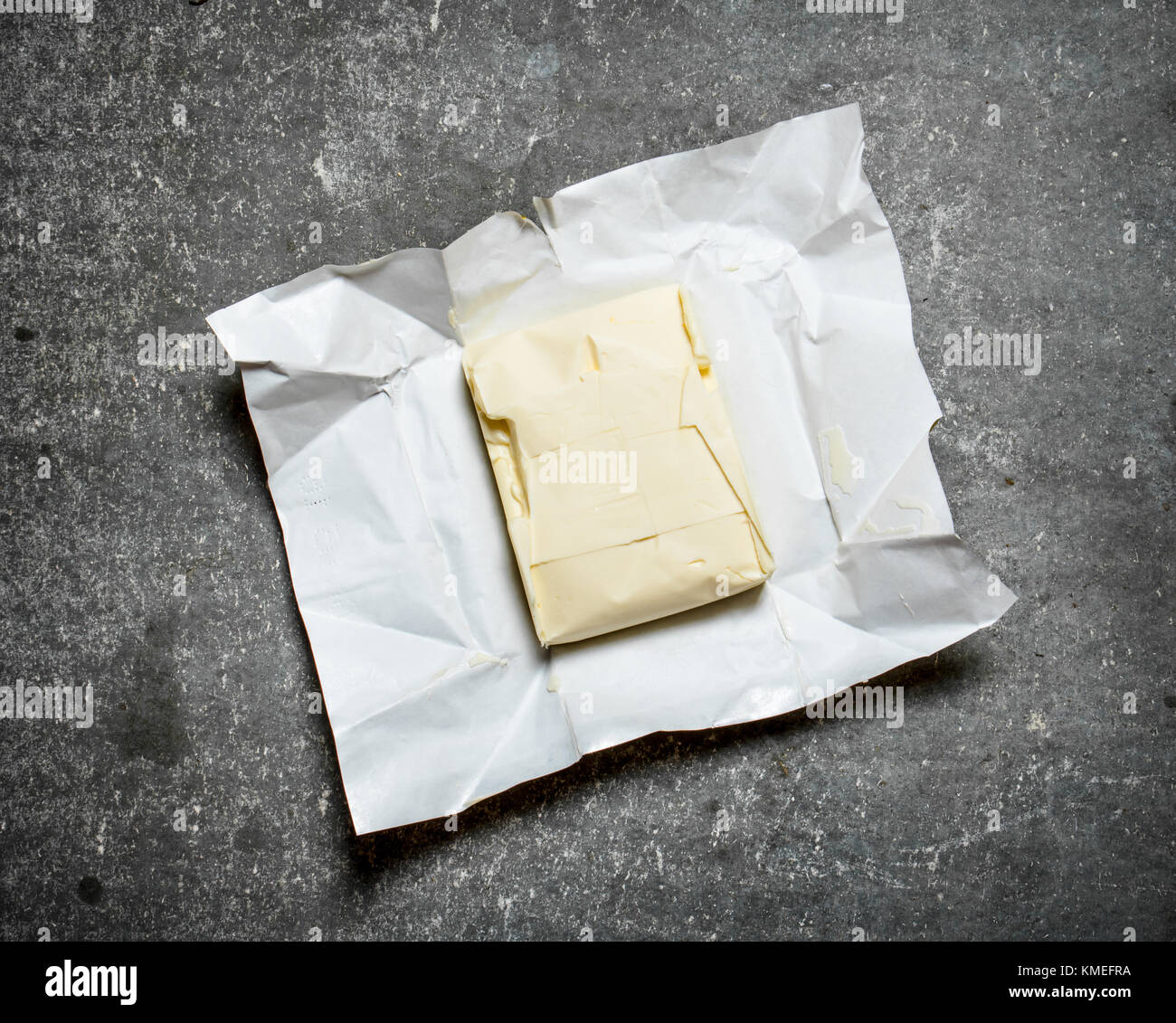 Butter on paper . On the stone table Stock Photo - Alamy