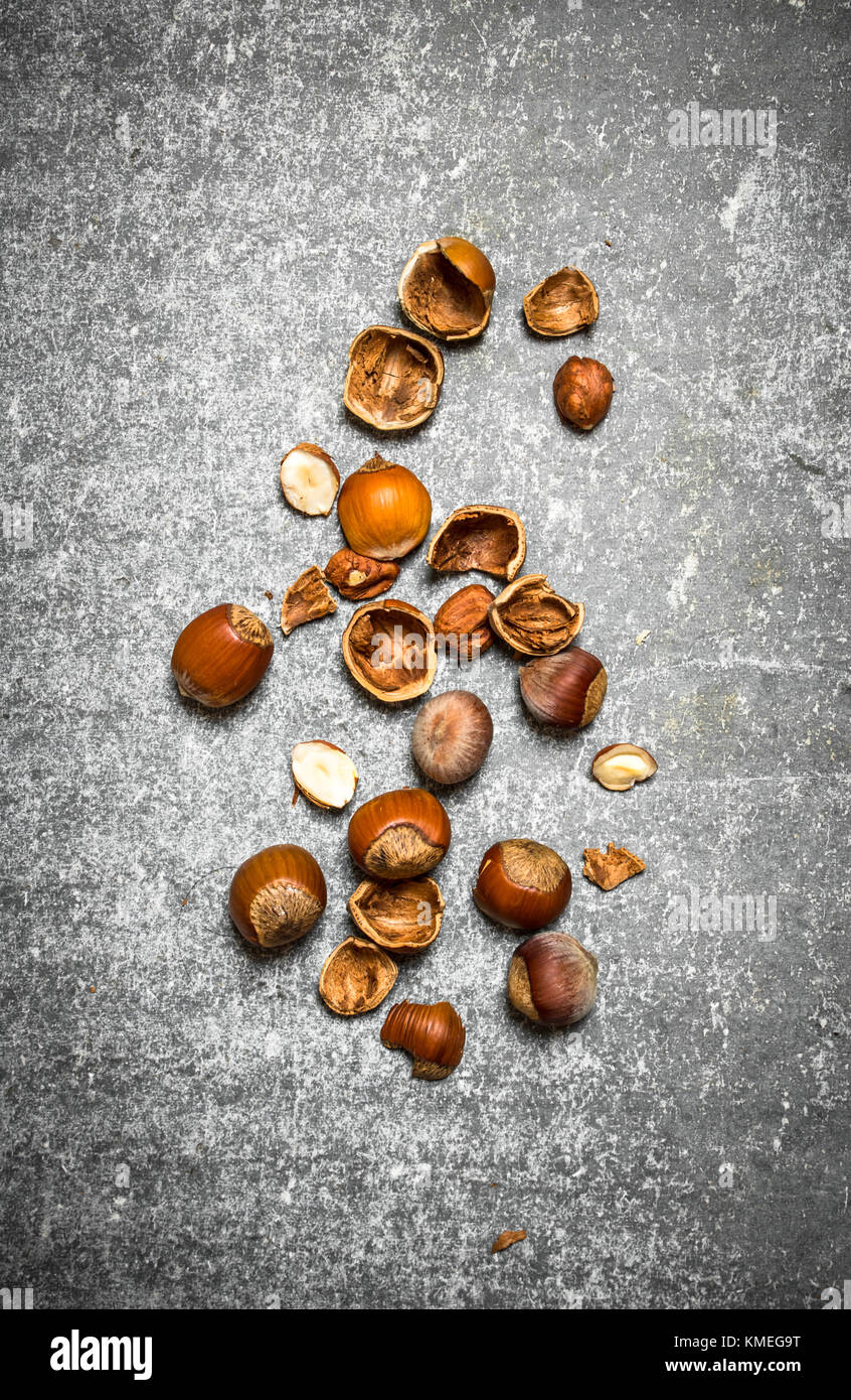 Nuts with shells. On the stone table Stock Photo - Alamy