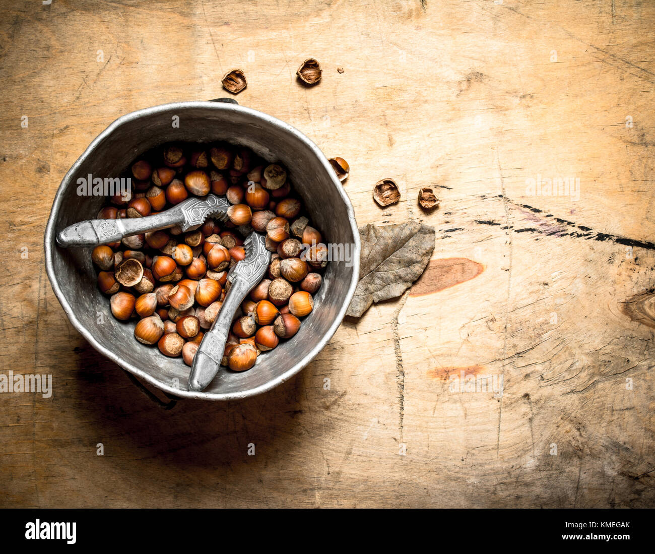Hazelnuts in the old pot. On a wooden table Stock Photo - Alamy