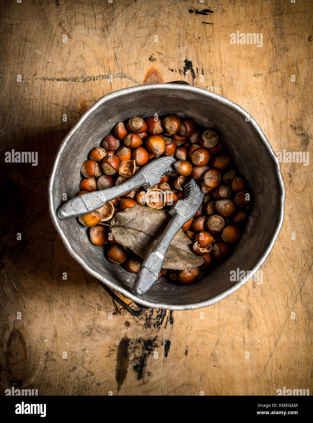 Hazelnuts in the old pot. On a wooden table Stock Photo - Alamy