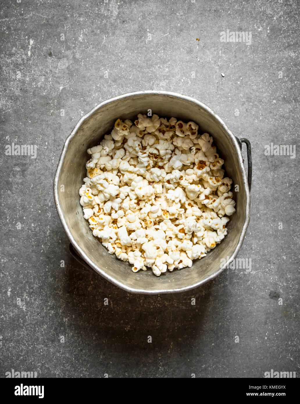 Popcorn in an old pot. On the Stone table Stock Photo - Alamy